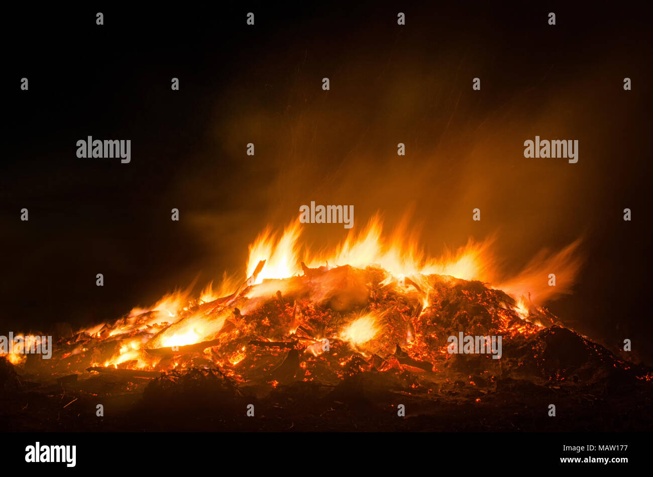 fire flames erupting from a huge Easter bonfire in the rural night ...