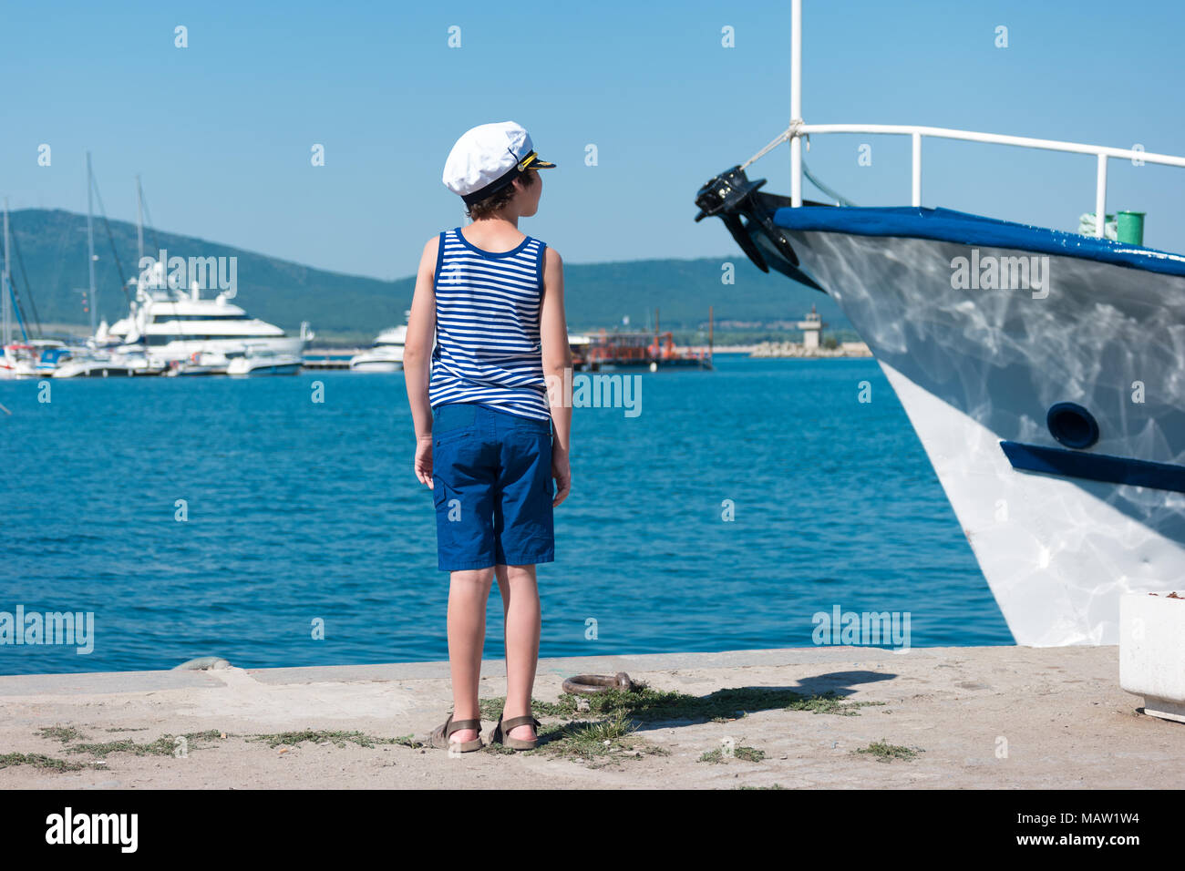 Boy standing at seaport hi-res stock photography and images - Alamy