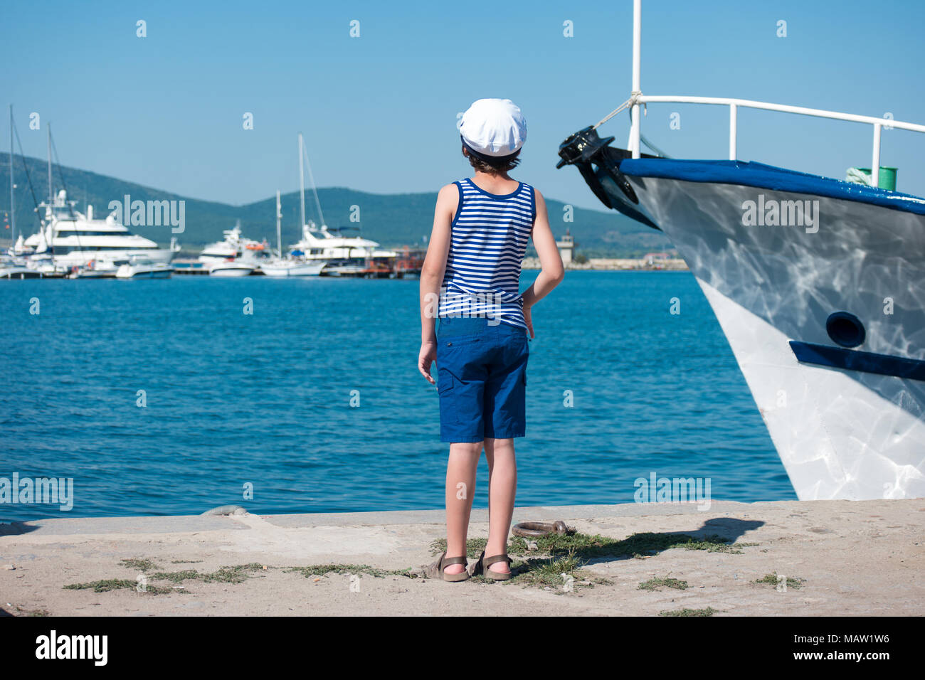 Boy standing at seaport hi-res stock photography and images - Alamy
