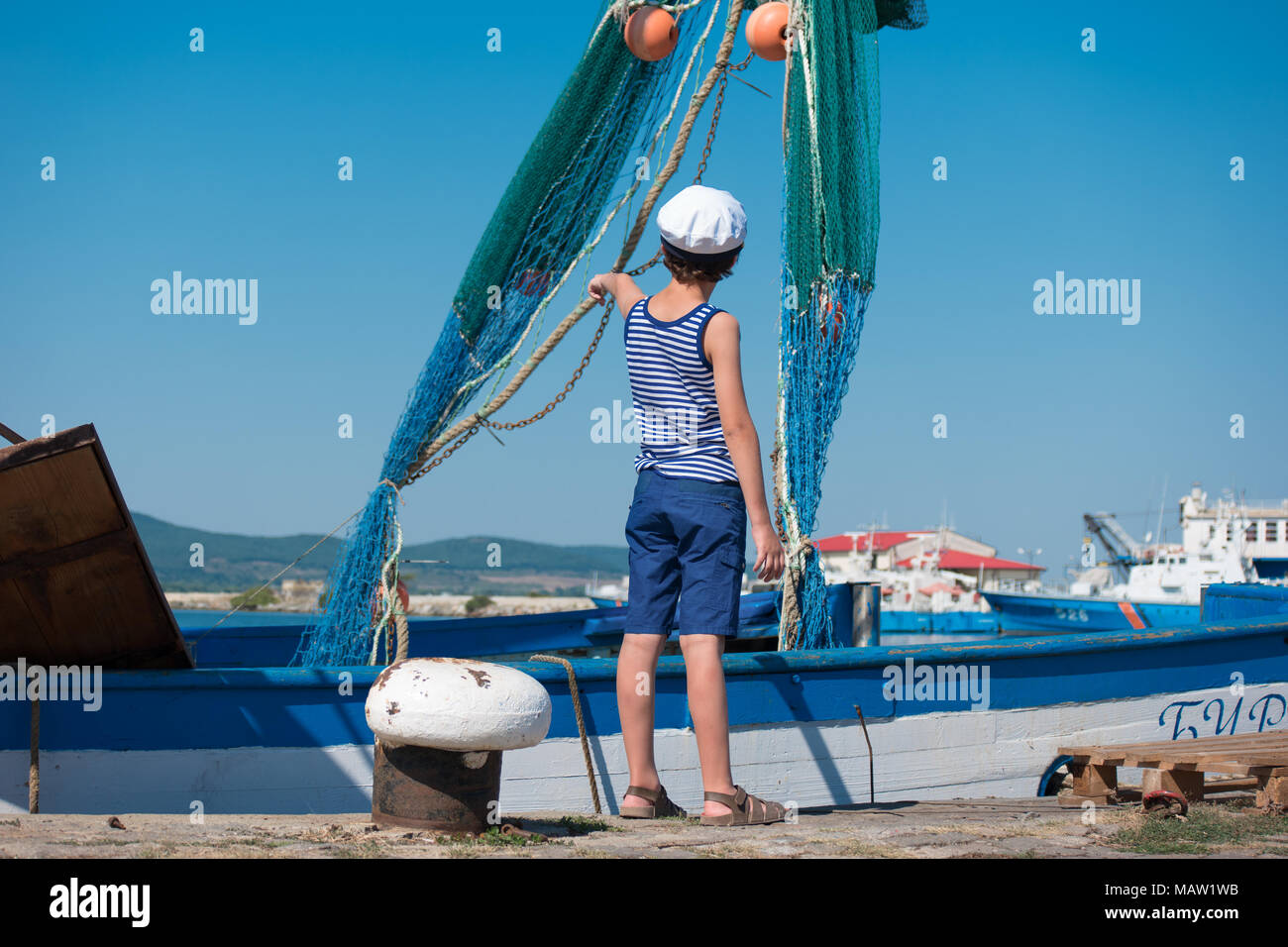 Boy standing at seaport hi-res stock photography and images - Alamy