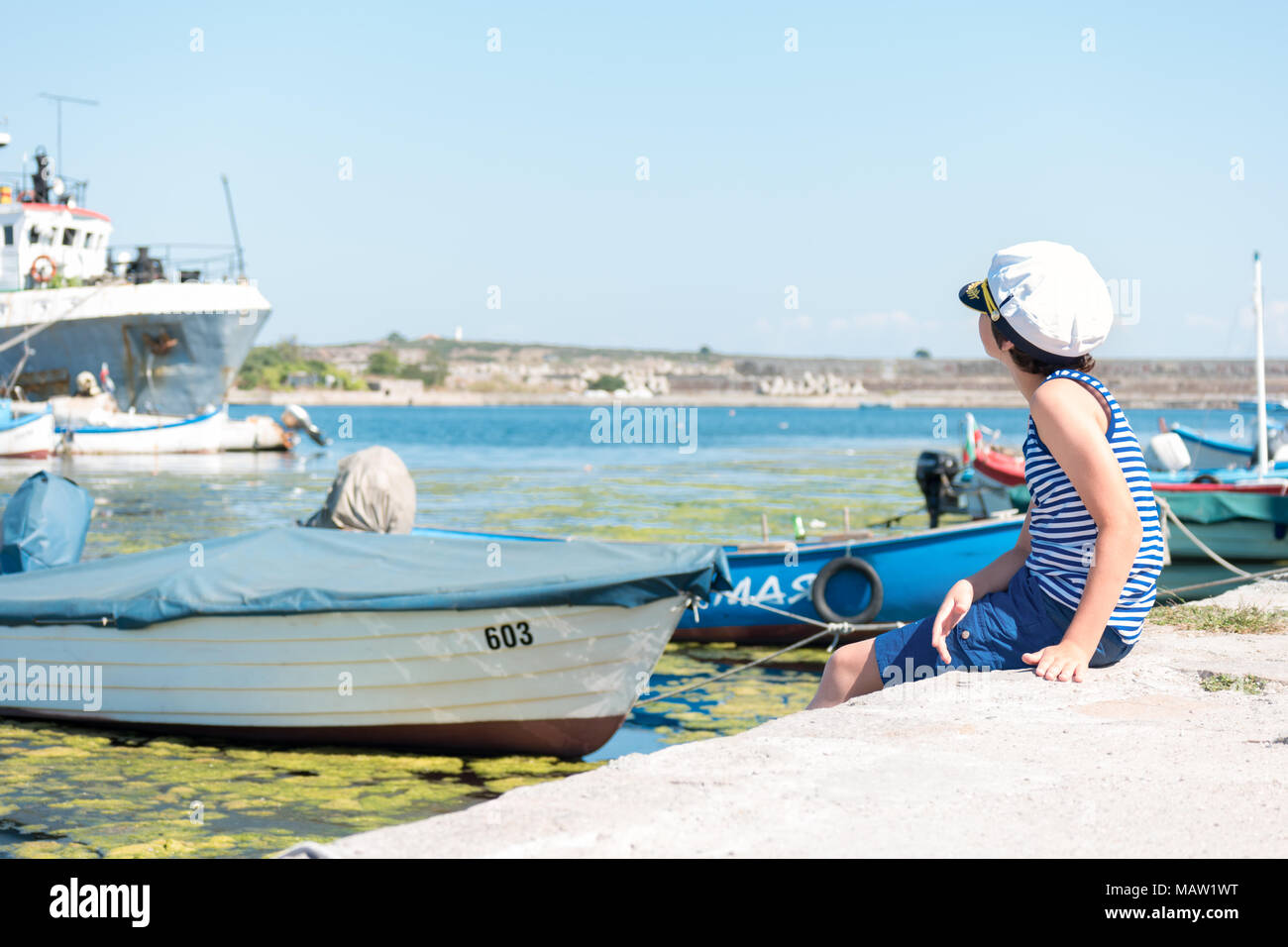 Boy standing at seaport hi-res stock photography and images - Alamy