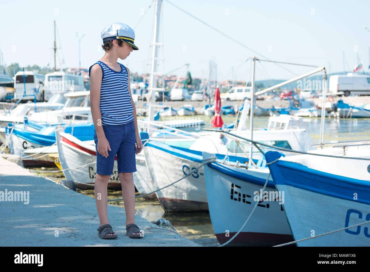 Boy standing at seaport hi-res stock photography and images - Alamy