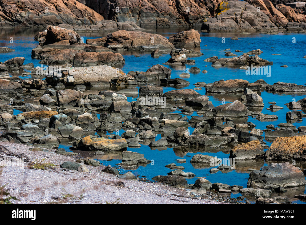 Large sharp stones in the water. Stony sea shore. Background Stock ...