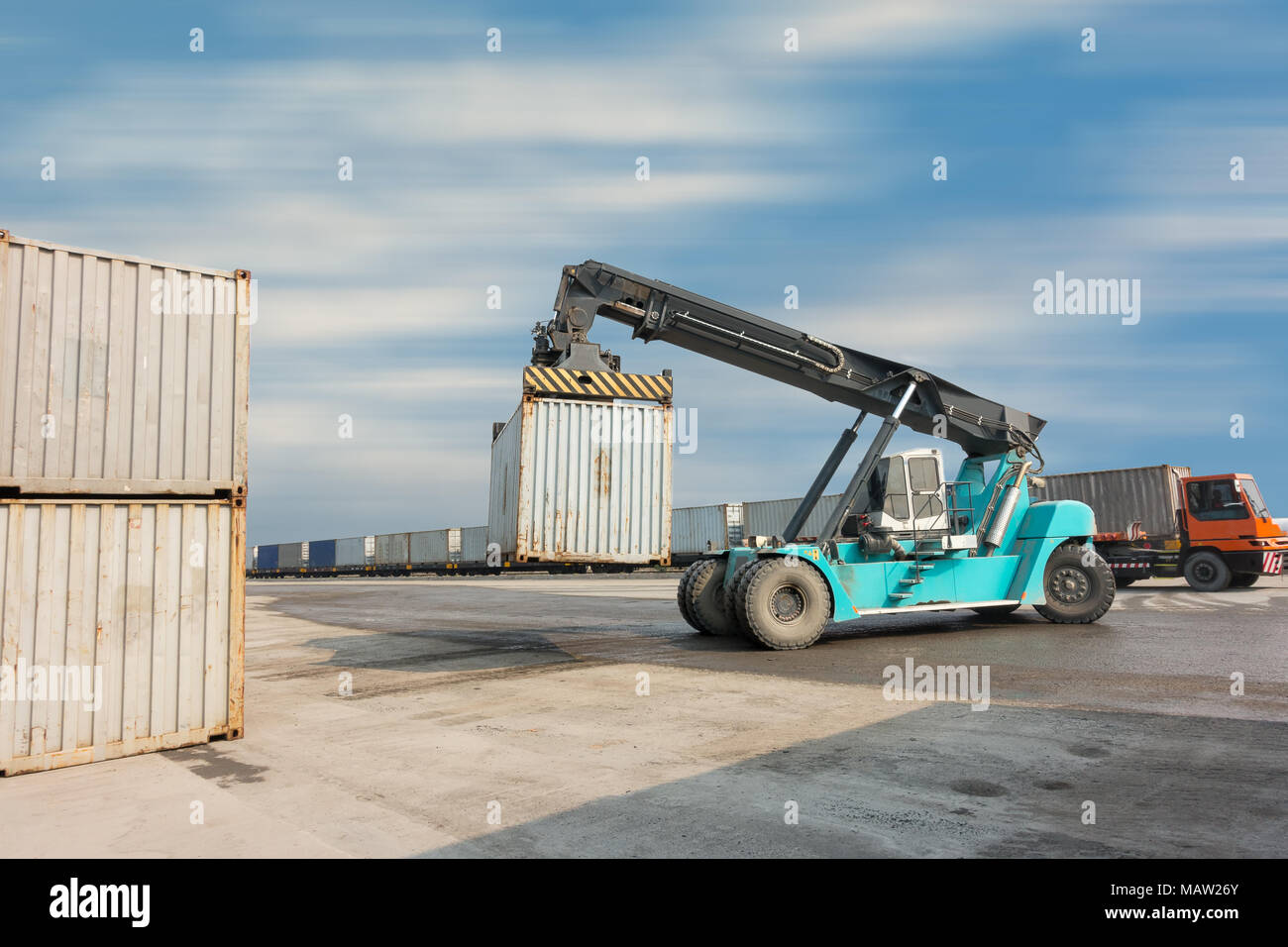 Container unloading truck in logistics yard Stock Photo - Alamy