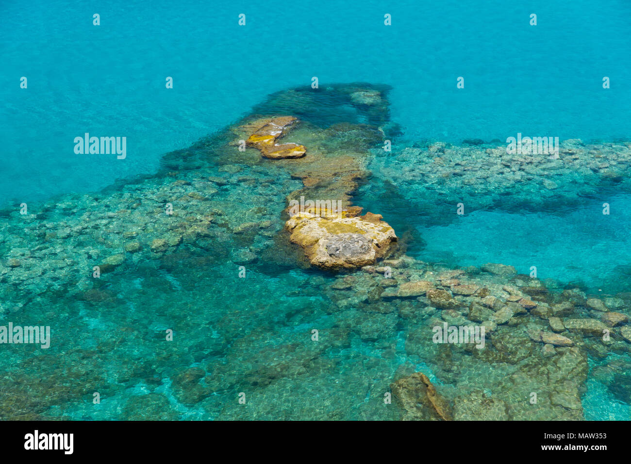 Blue sea water washing rocky shore Stock Photo - Alamy