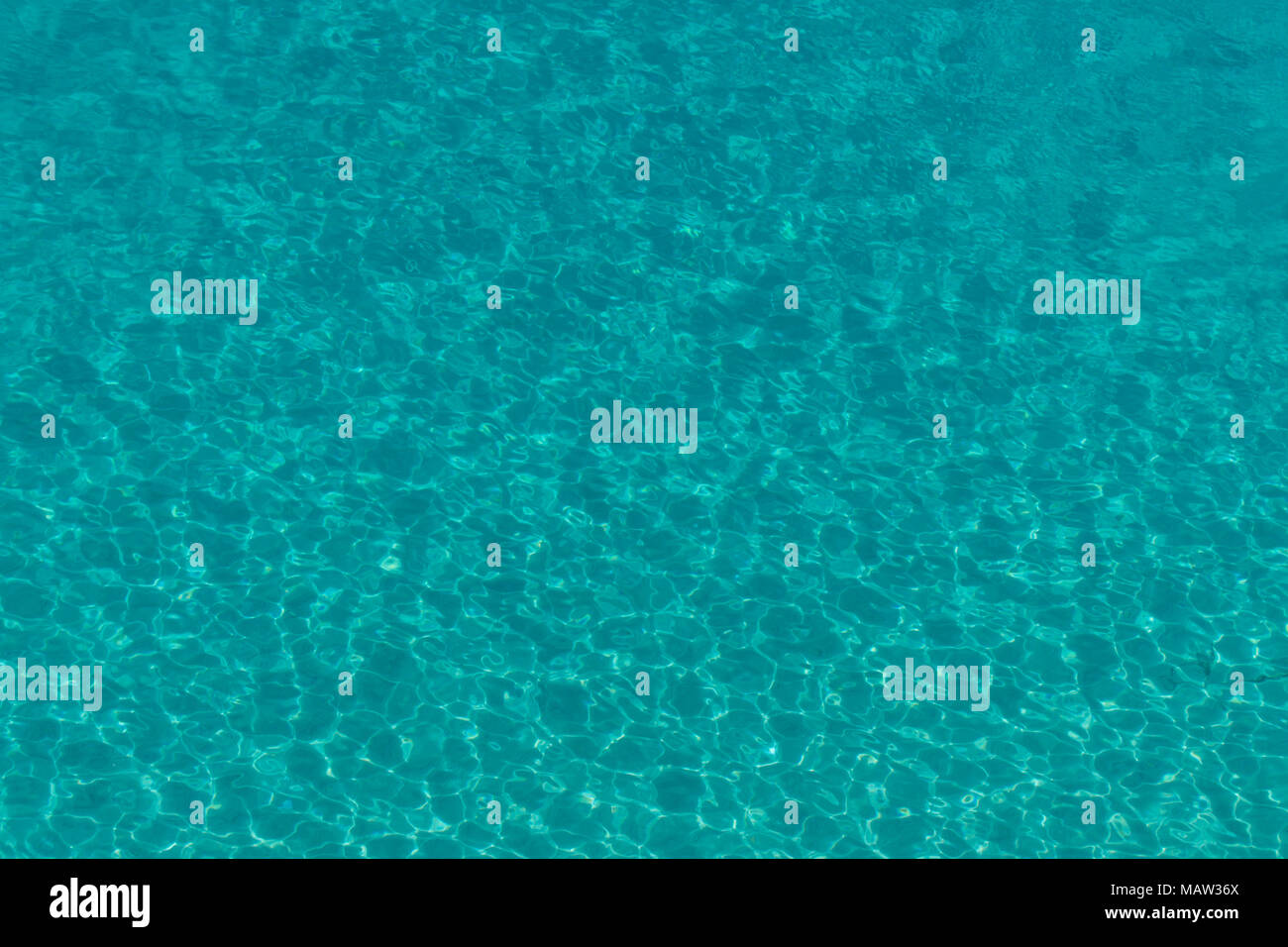 Blue sea water washing rocky shore Stock Photo - Alamy