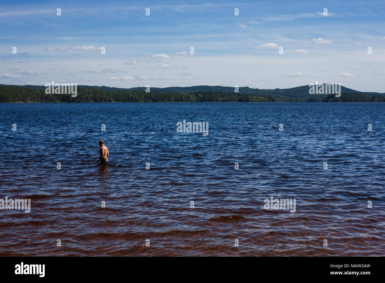 A man wading in a lake near Kopparberg, Sweden Stock Photo - Alamy