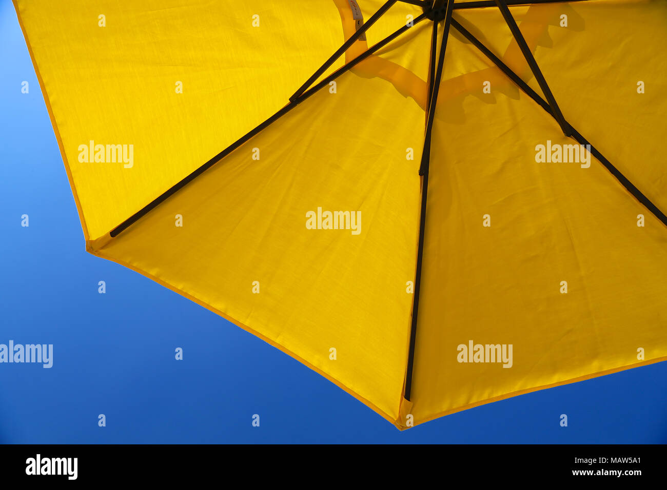 Blue and yellow umbrella hi-res stock photography and images - Alamy