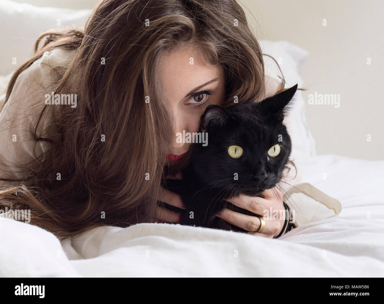 Woman cat on bed hi-res stock photography and images - Alamy
