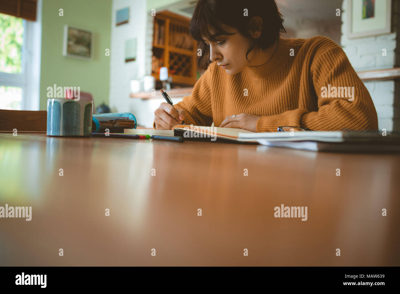 Woman drawing a sketch in a book Stock Photo - Alamy