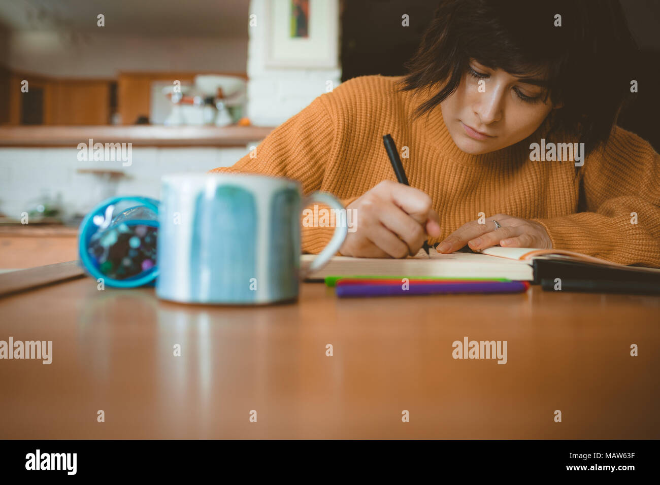 Woman drawing a sketch in a book Stock Photo - Alamy