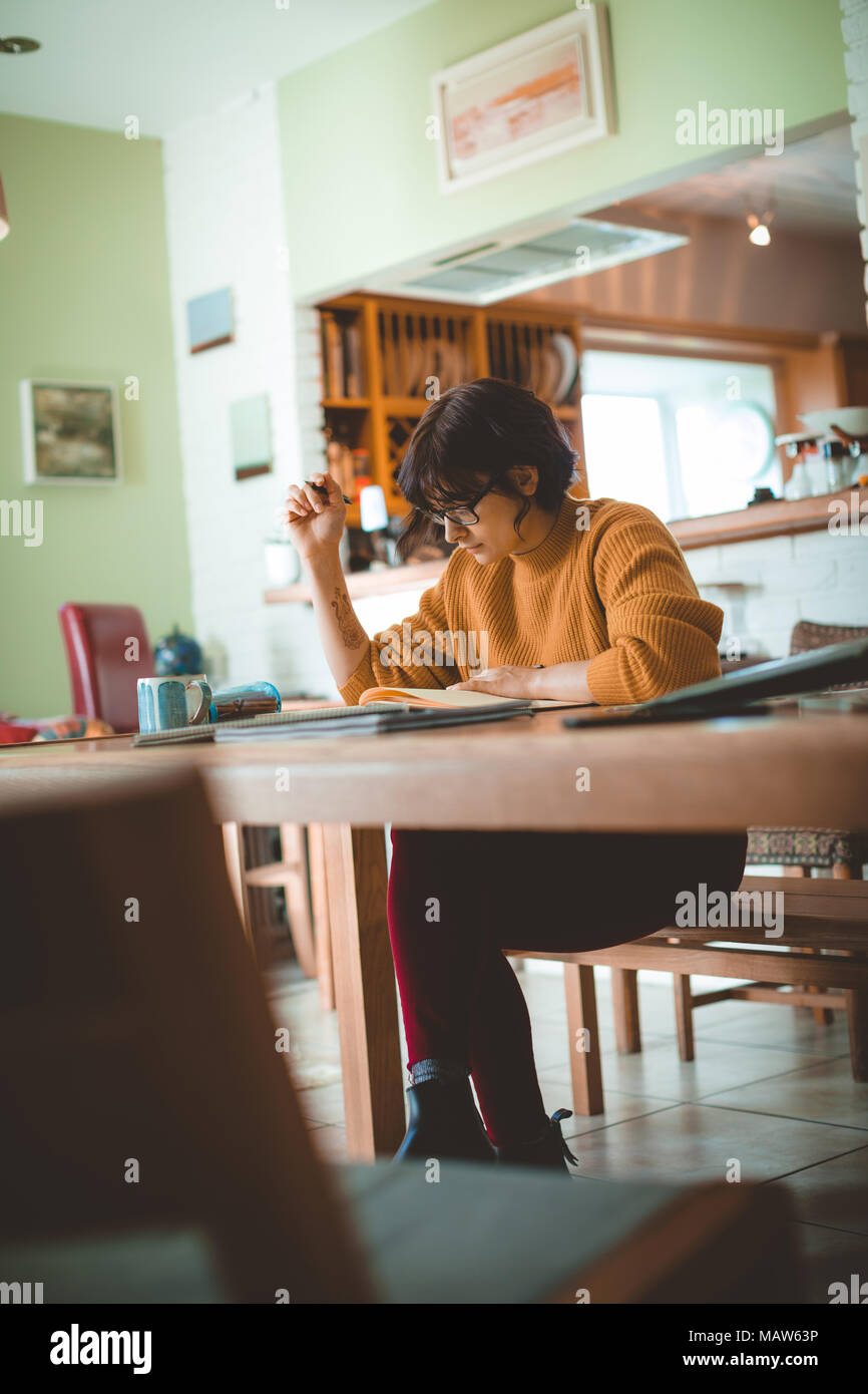 Woman drawing a sketch in a book Stock Photo - Alamy