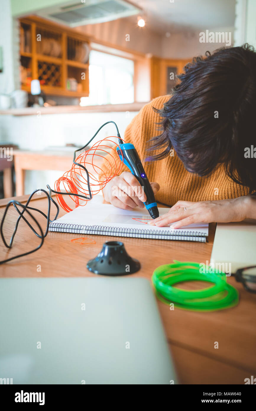Woman drawing a sketch in a book Stock Photo - Alamy