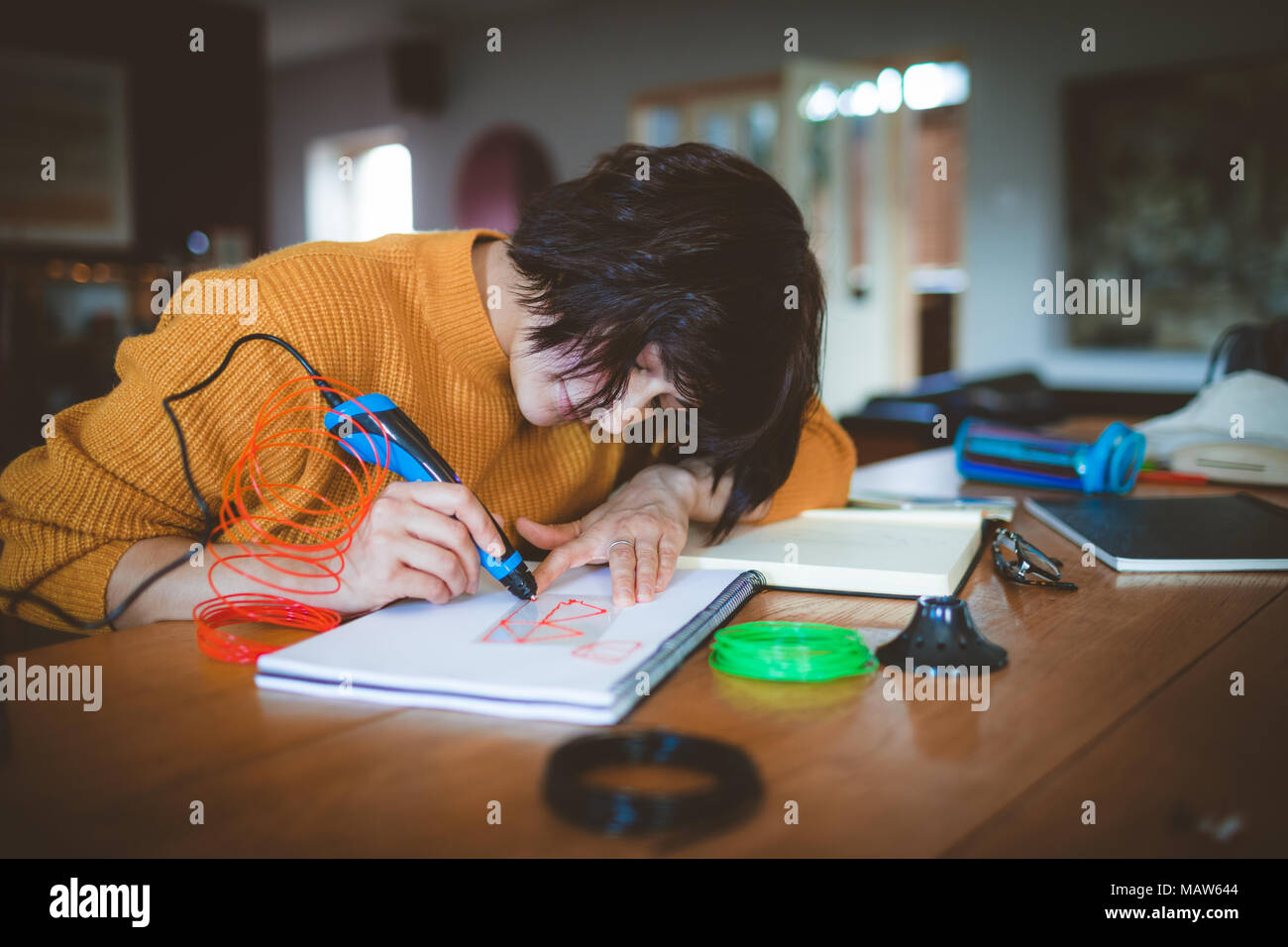 Woman drawing a sketch in a book Stock Photo - Alamy