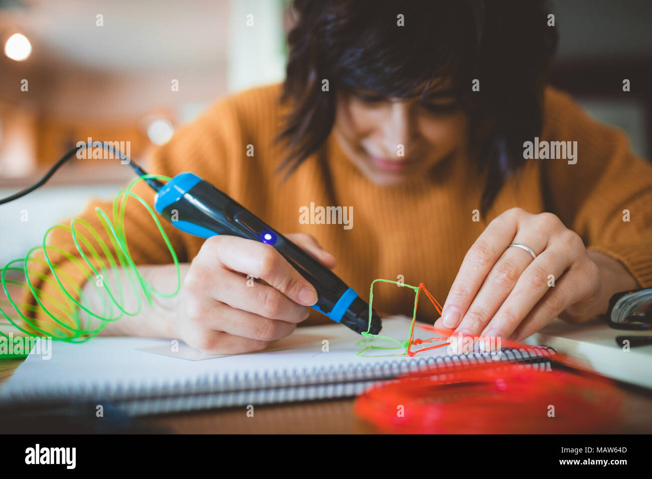 Woman drawing a sketch in a book Stock Photo - Alamy