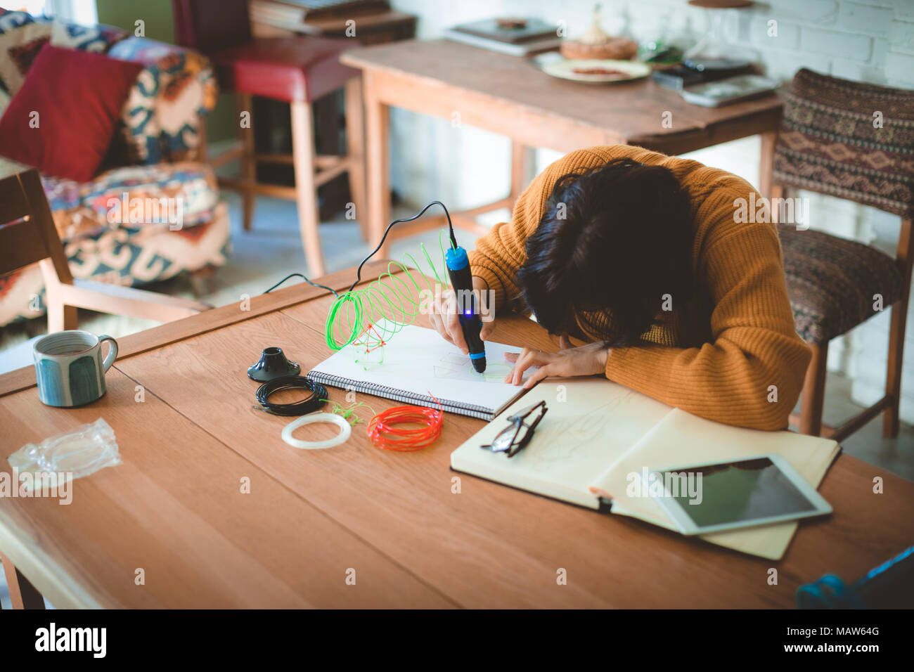 Woman drawing a sketch in a book Stock Photo - Alamy