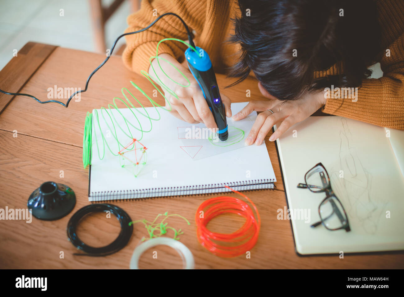 Woman drawing a sketch in a book Stock Photo - Alamy