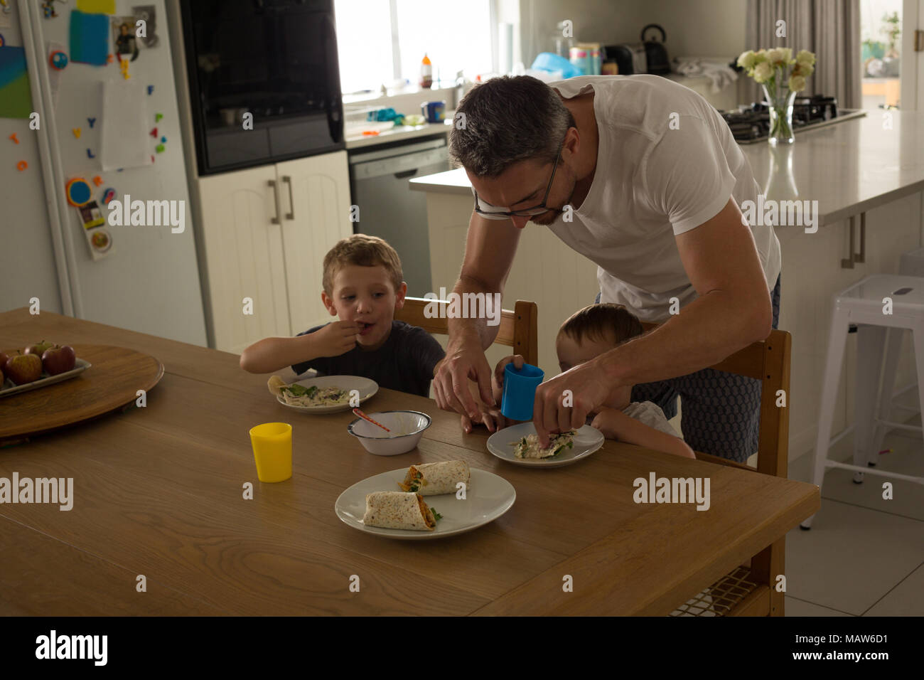 Father and son at breakfast table hi-res stock photography and images ...