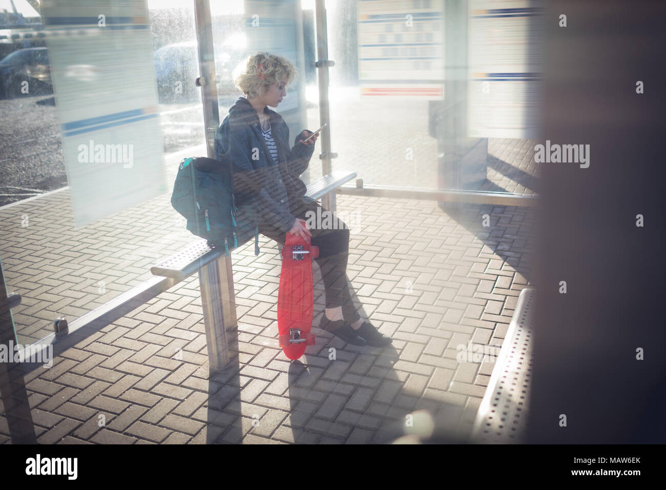 Woman bus stop phone hi-res stock photography and images - Alamy