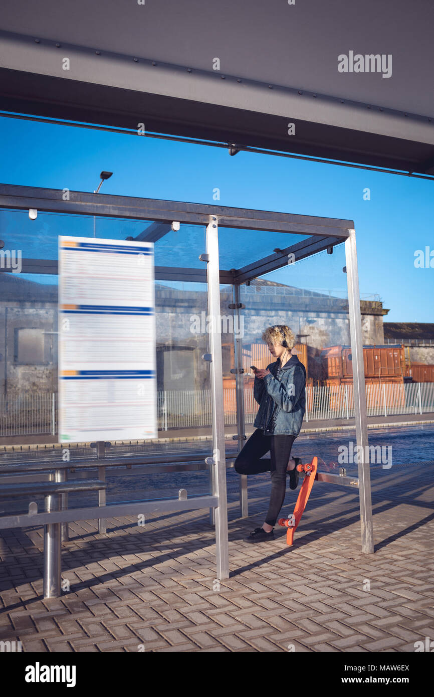 Woman bus stop phone hi-res stock photography and images - Alamy