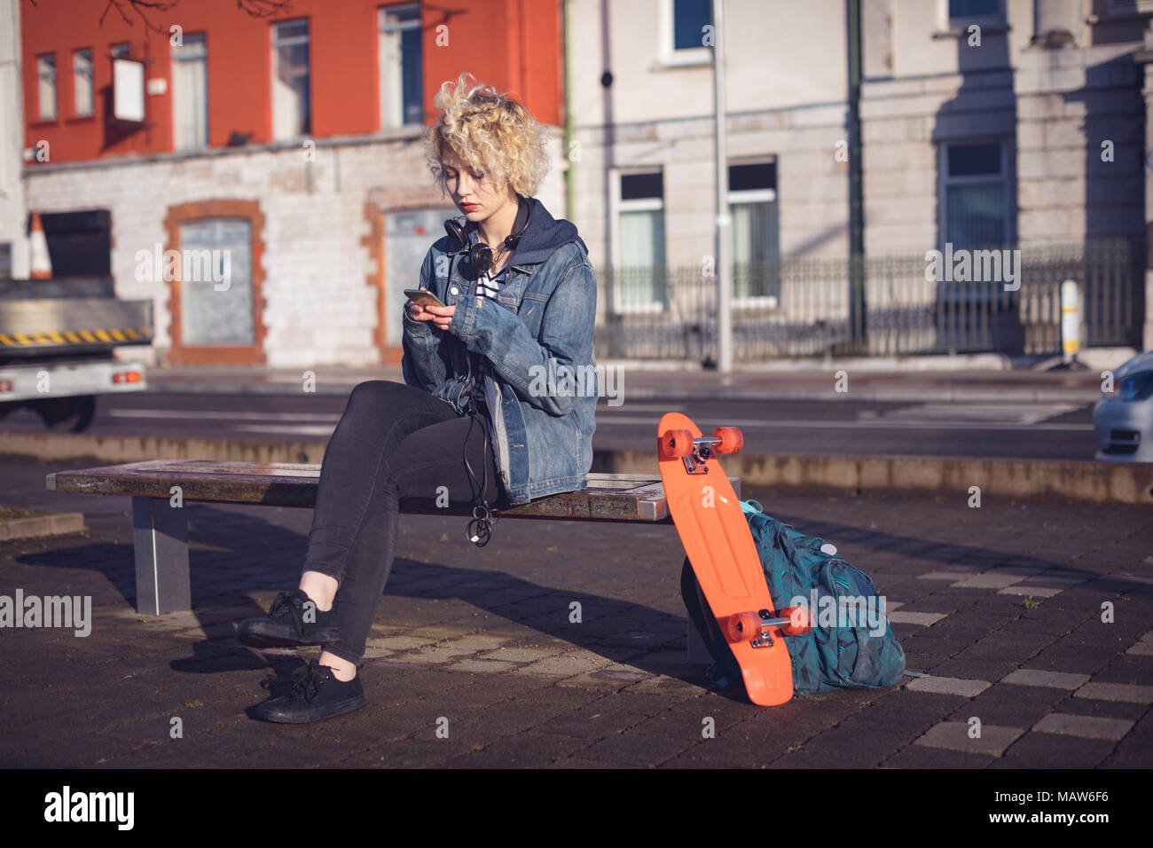 Woman using mobile phone in city street Stock Photo - Alamy
