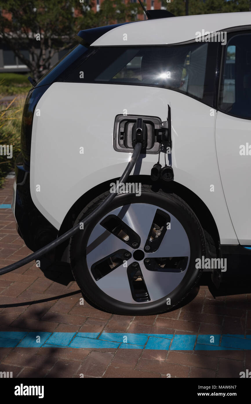Electric car being charged at charging station Stock Photo - Alamy