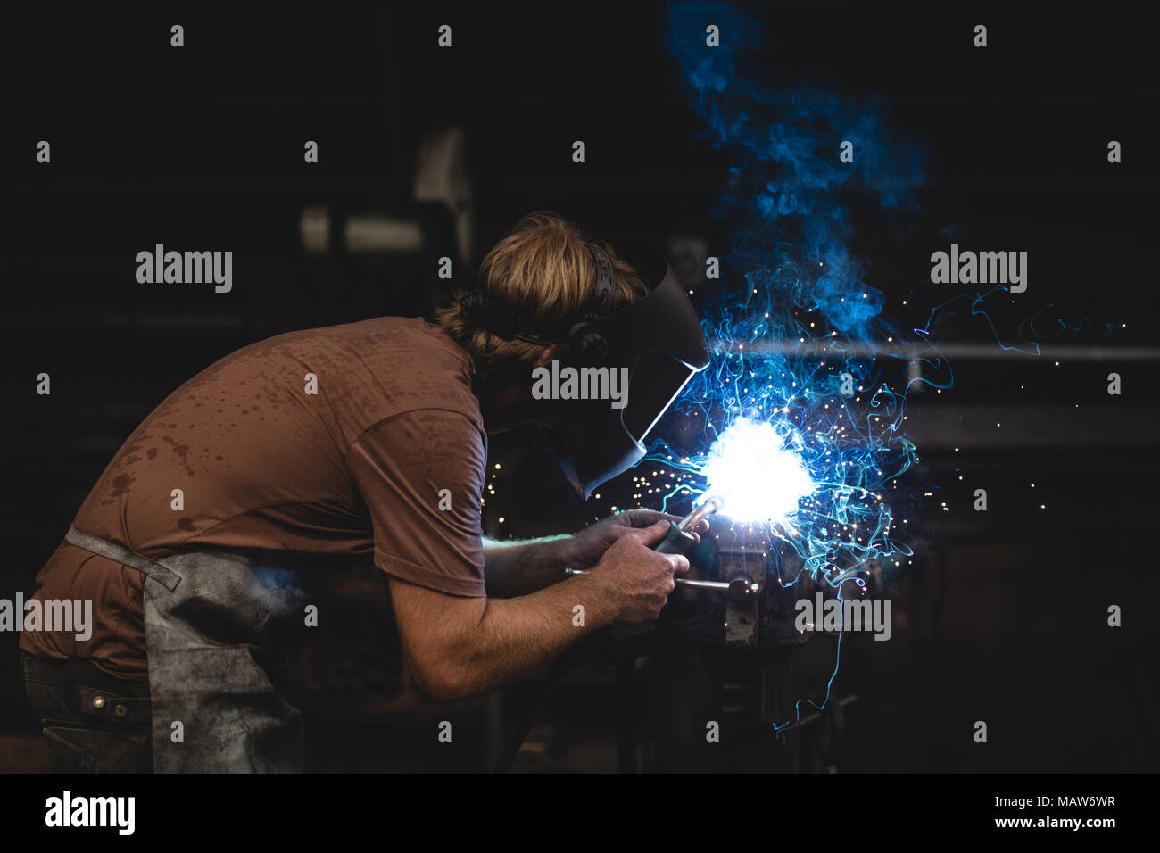 Blacksmith using a welding torch Stock Photo - Alamy
