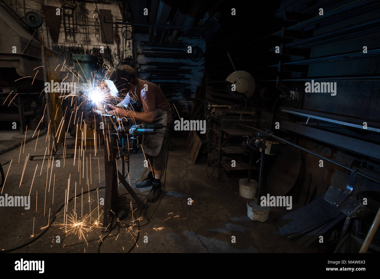 Blacksmith using a welding torch Stock Photo - Alamy