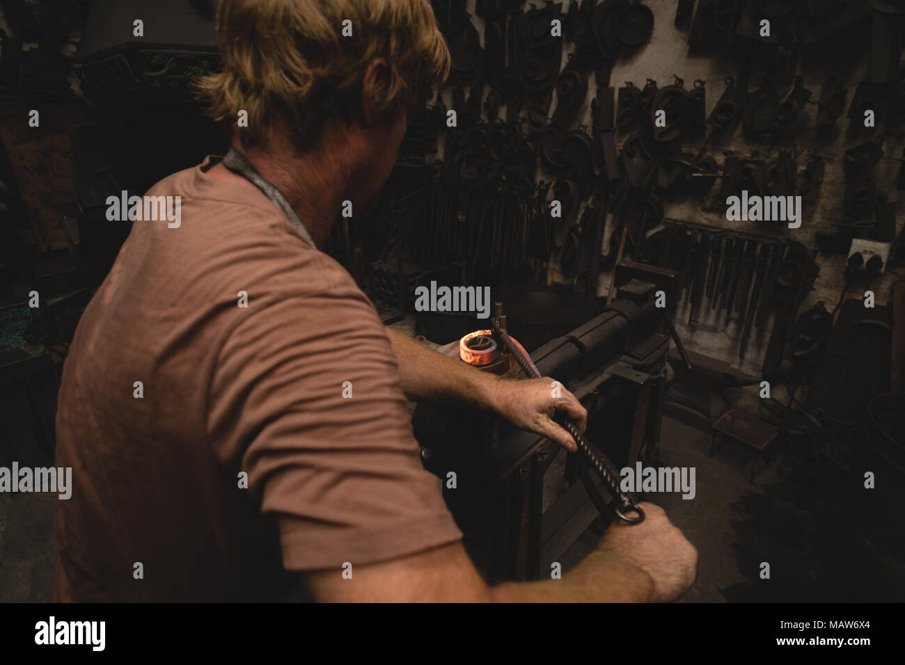 Male blacksmith hammering metalwork hi-res stock photography and images ...