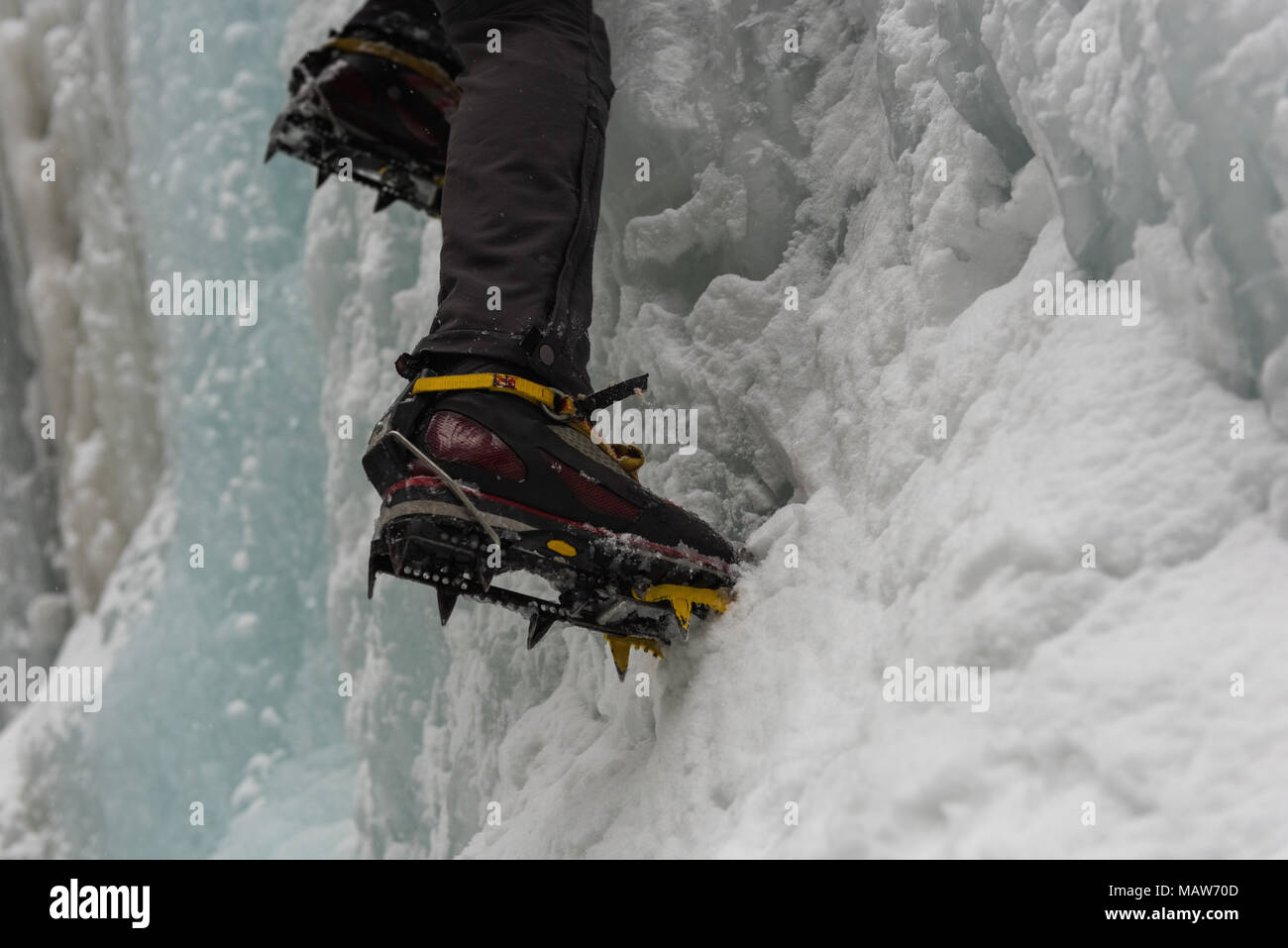 Male rock climber climbing ice mountain Stock Photo - Alamy