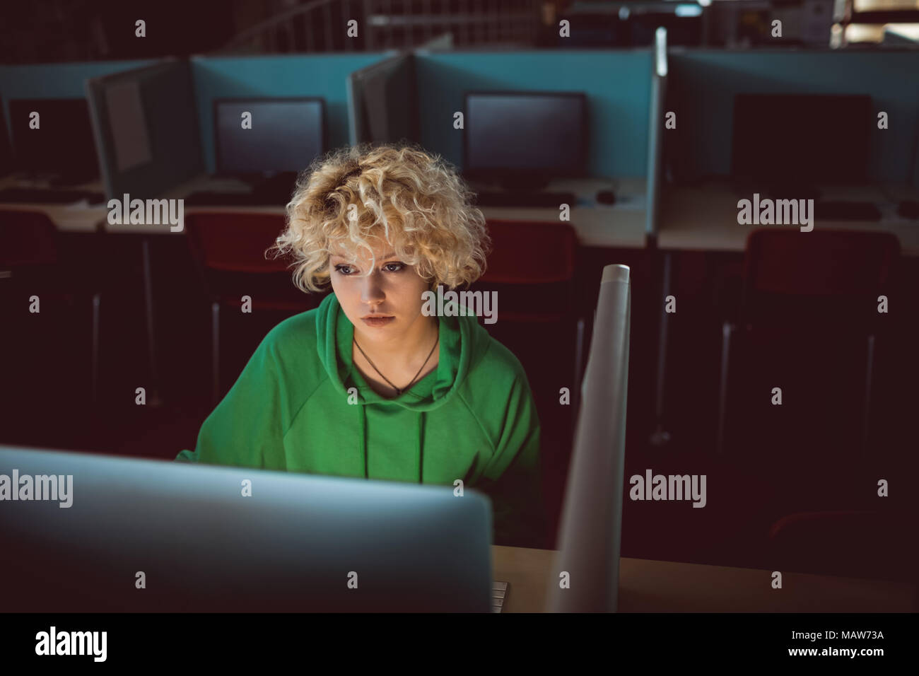 Woman working on computer in library Stock Photo - Alamy