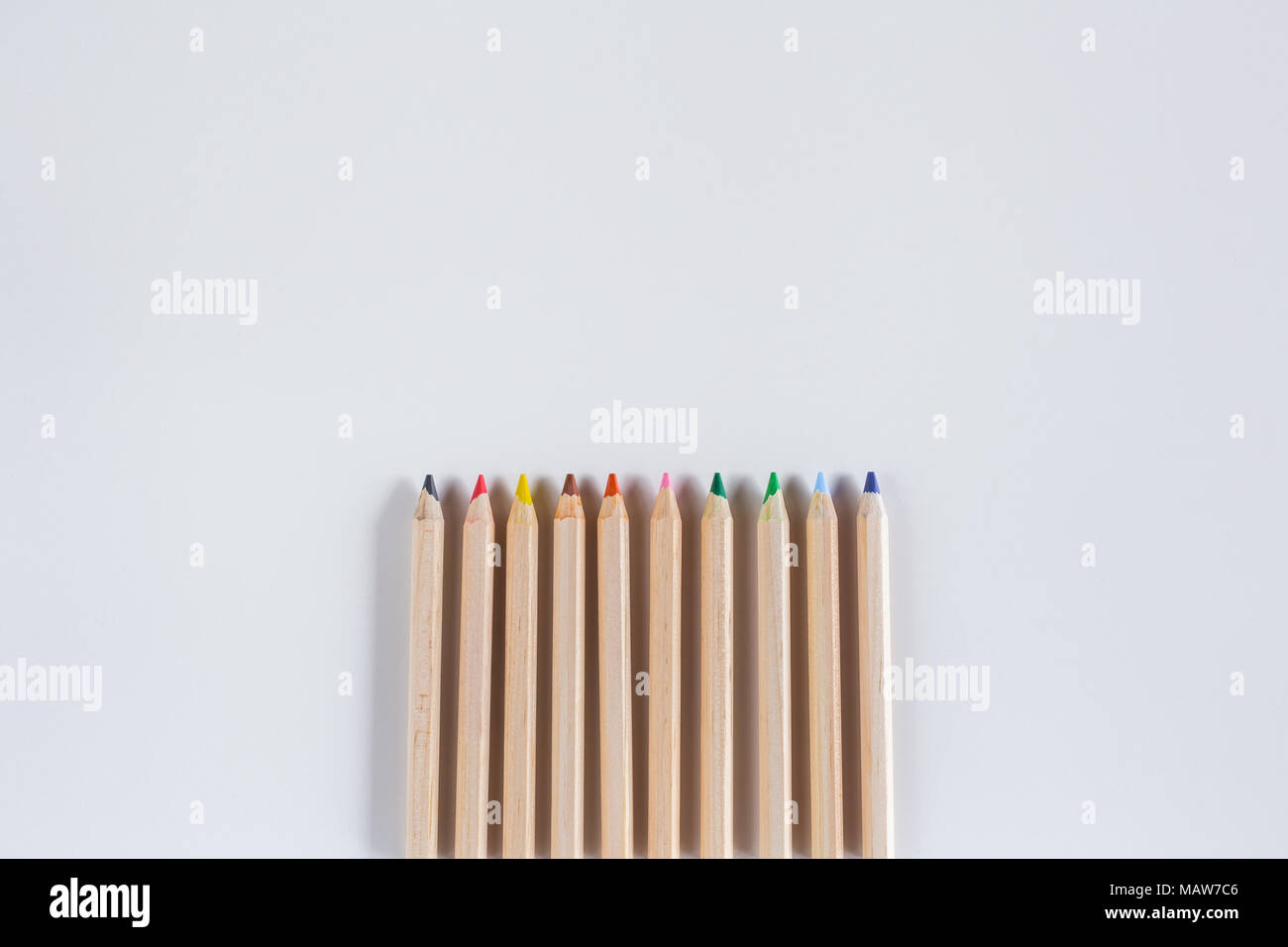 Color pencils are used. On the ground is a white paper prepared for ...