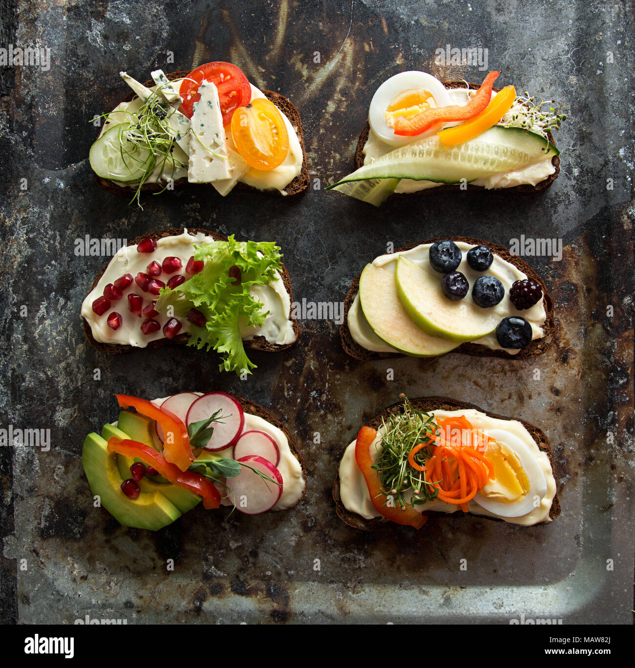 Healthy breakfast toasts with vegetables, fruits and microgreen on ...