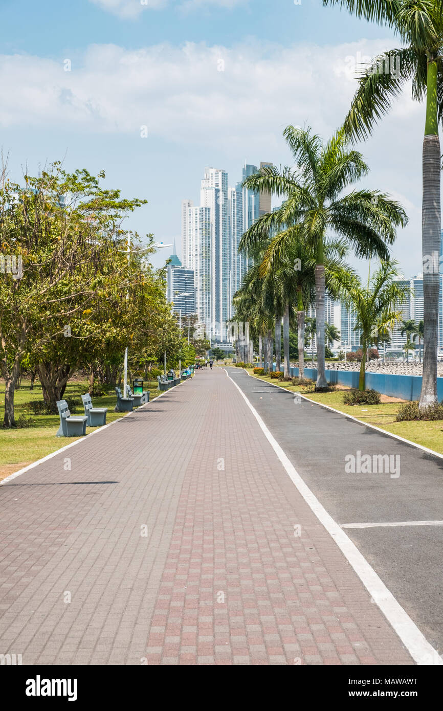 Sidewalk at public park with city skyline at coast promenade in Panama ...