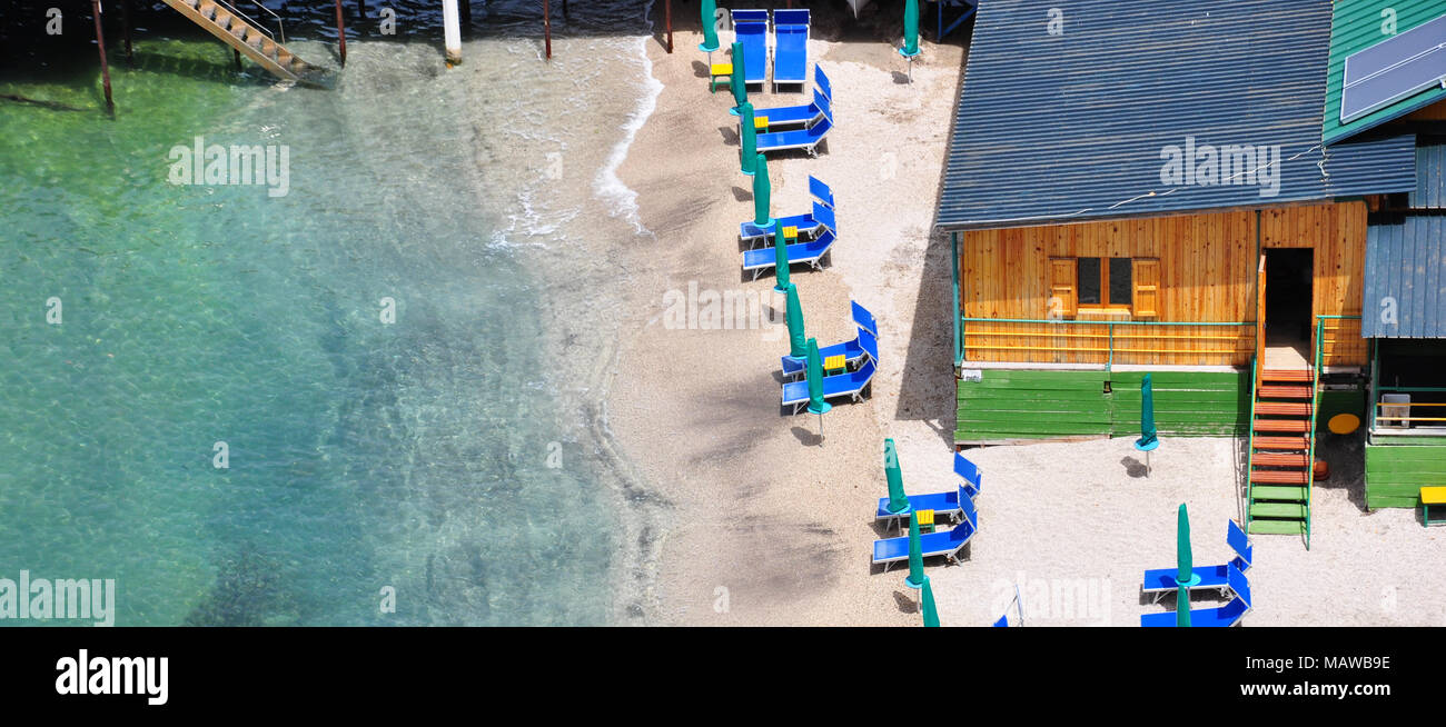 Cottage on the beautiful sand beach with blue sunbeds on the Capri ...