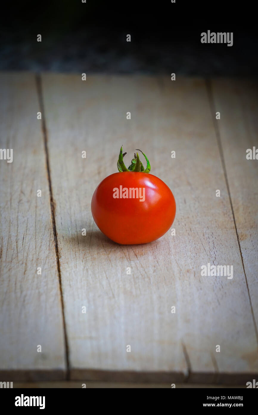 One green tomato above one red tomato hi-res stock photography and ...