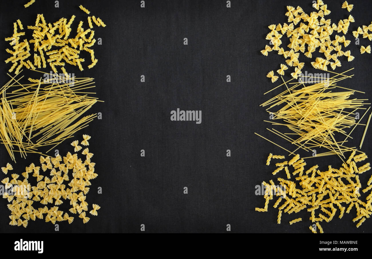 Pasta on black background, above view, copy space, flat lay style Stock ...