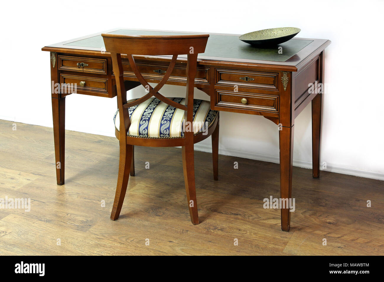 Retro working desk in empty room with wooden floors Stock Photo - Alamy