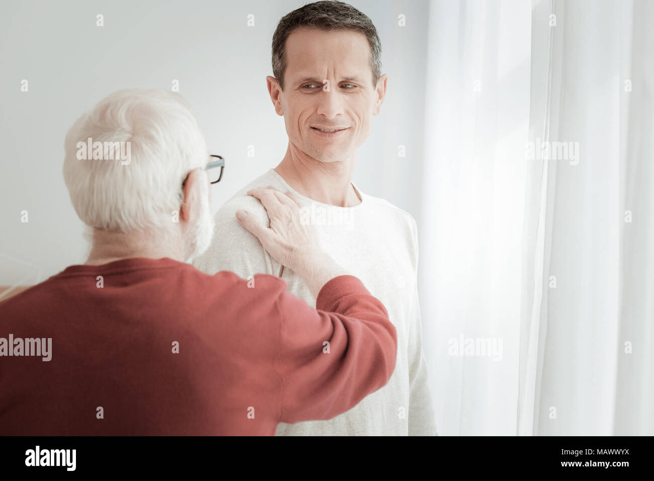 Interested handsome man standing and looking at another man Stock Photo ...