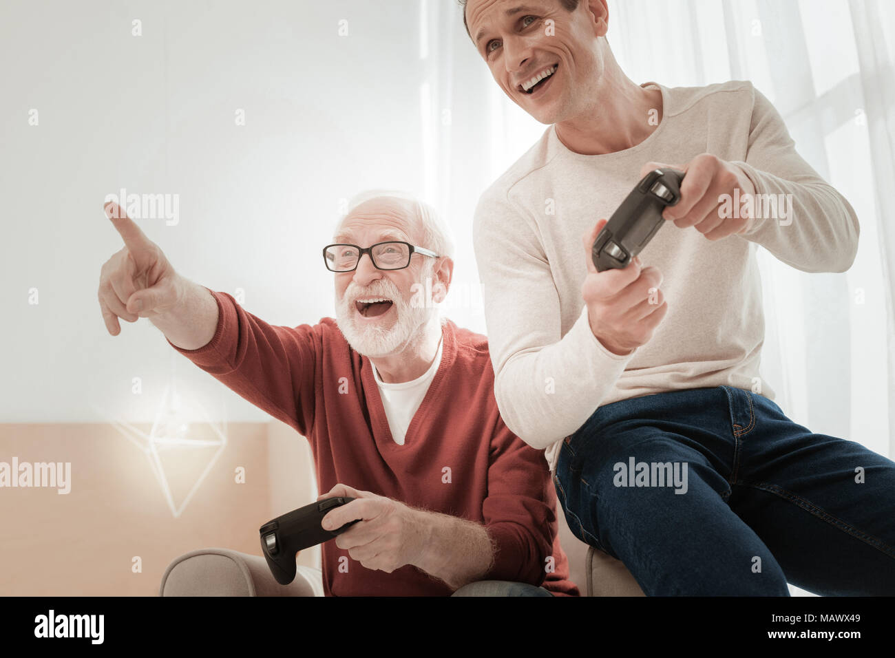 Satisfied friendly natives playing together and having fun Stock Photo ...