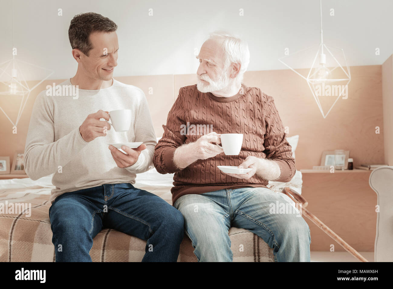 Calm friendly natives sitting and communicating Stock Photo - Alamy