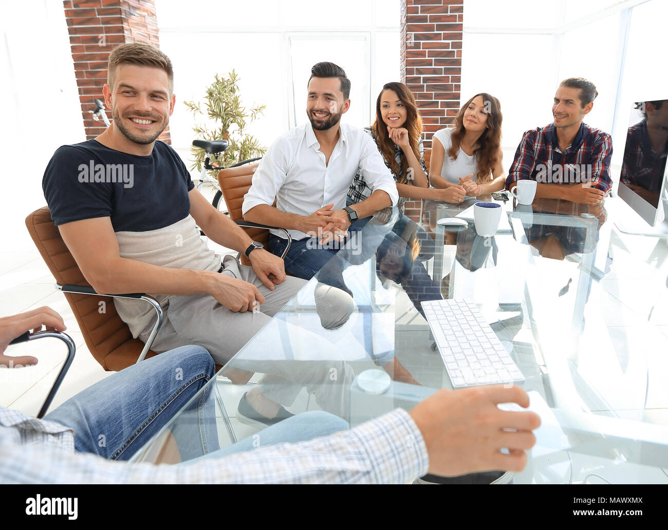 business team sitting at a modern Desk Stock Photo - Alamy
