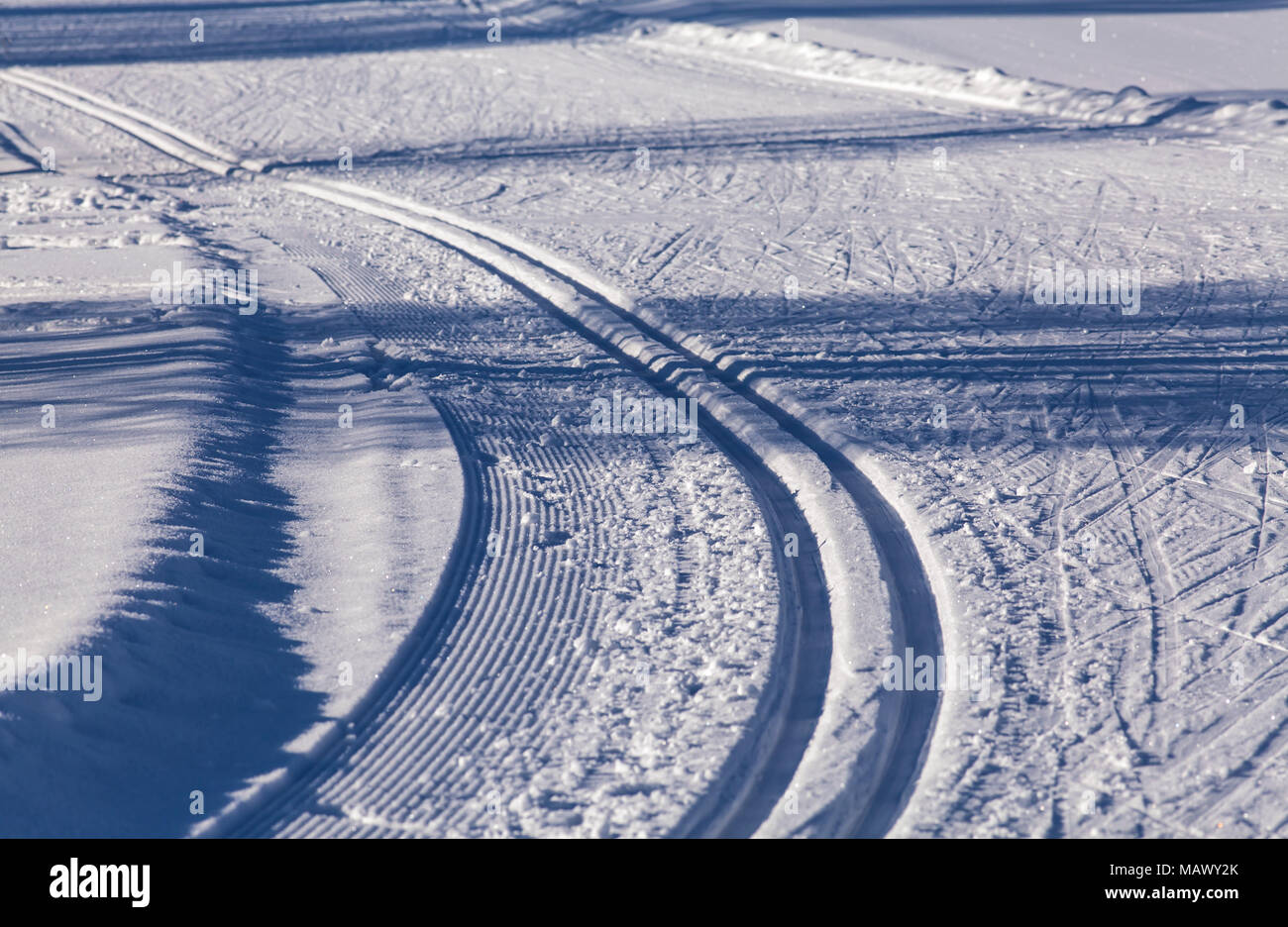 Closeup on Cross-country skiing tracks in winter landscape. Shadows and ...