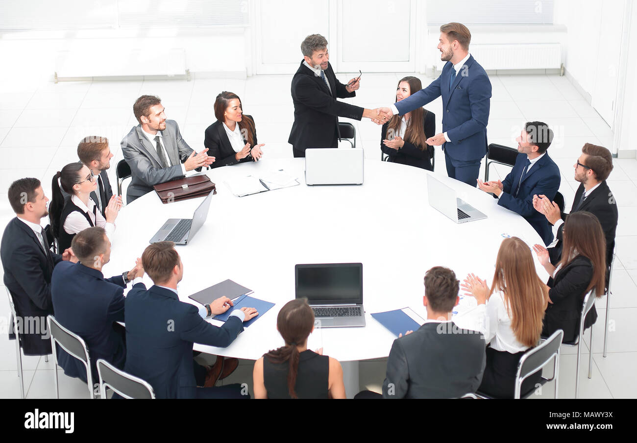 business partners shake hands at the talks near the round table Stock ...