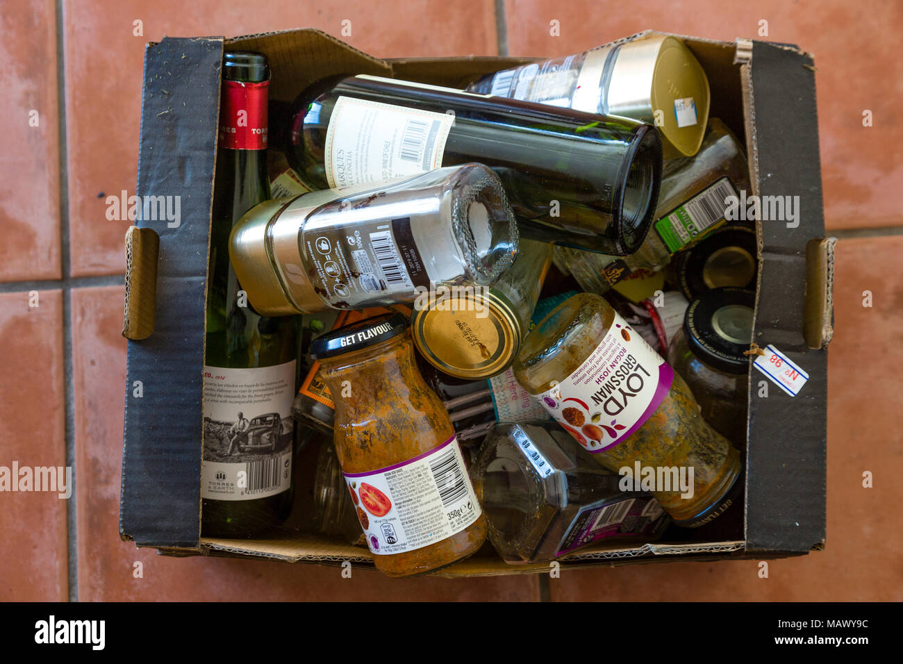 Cardboard box with glass bottles and jars for recycling Stock Photo - Alamy