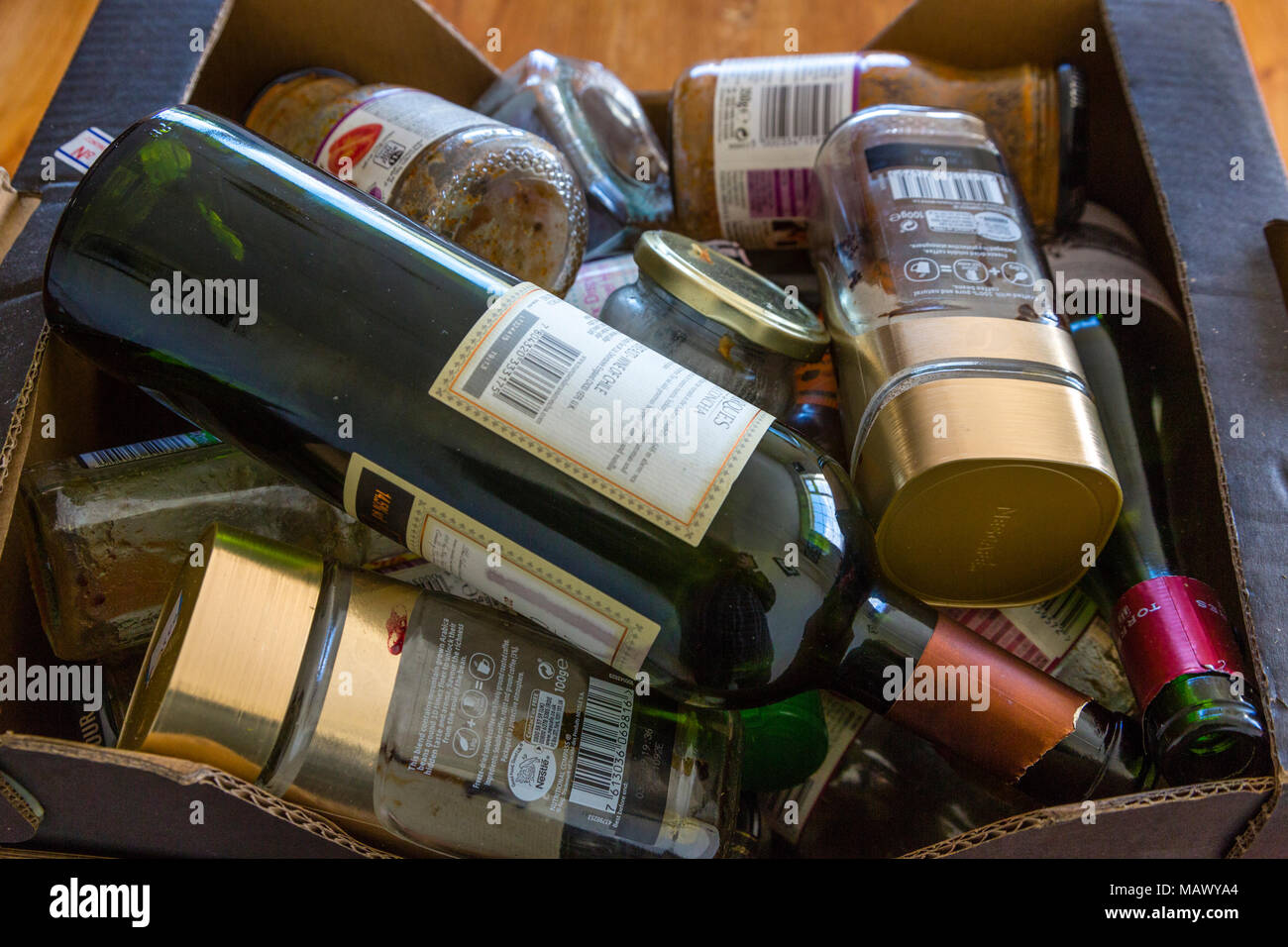 Cardboard box with glass bottles and jars for recycling Stock Photo - Alamy