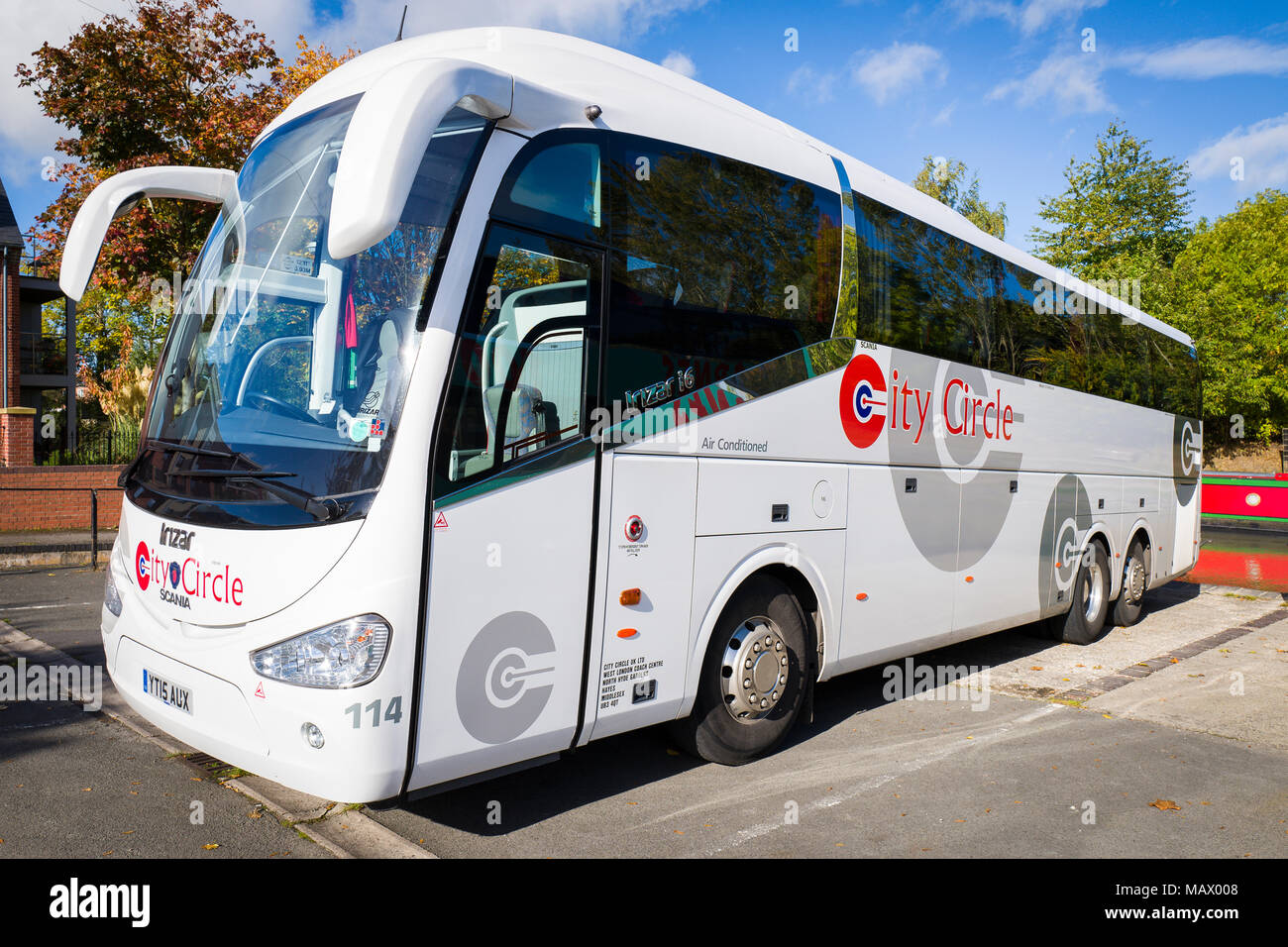A modern Inzar Scania single deck tourism coach parked beside the canal ...