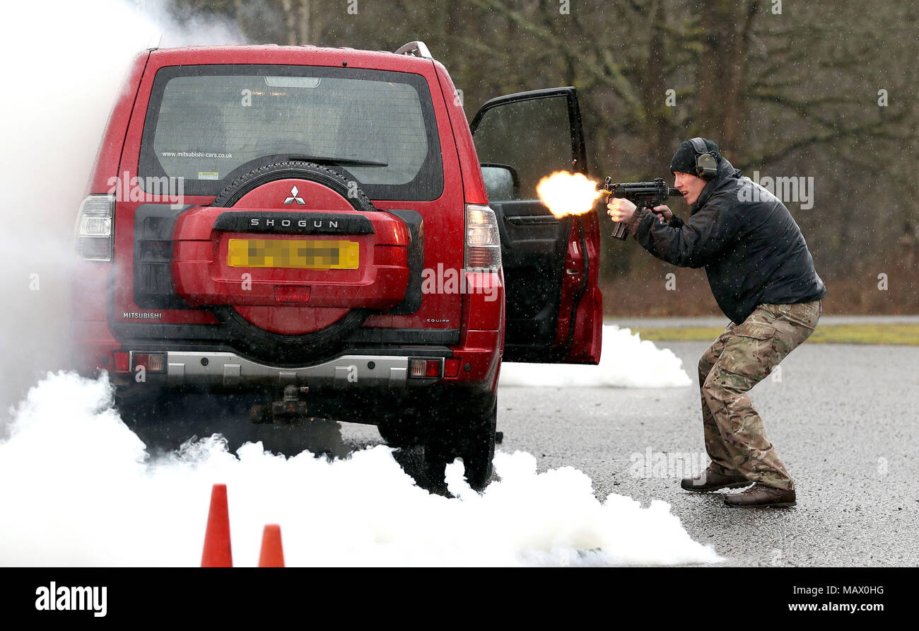 A soldier playing the enemy opens fire, as members of the Close ...
