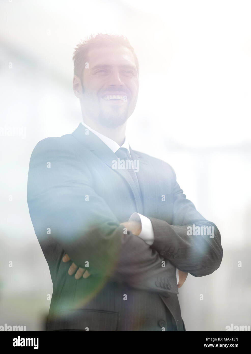 from behind the glass. modern businessman looks out the window of the ...
