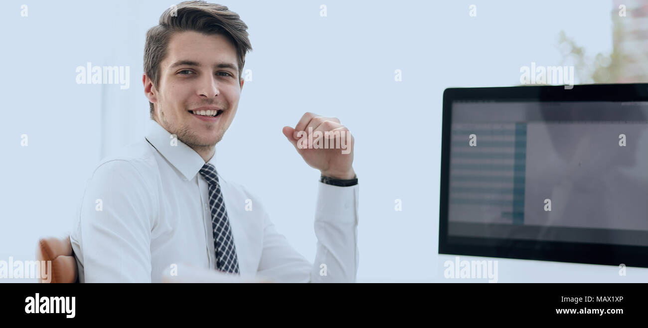 employee sitting in front of a computer screen Stock Photo - Alamy